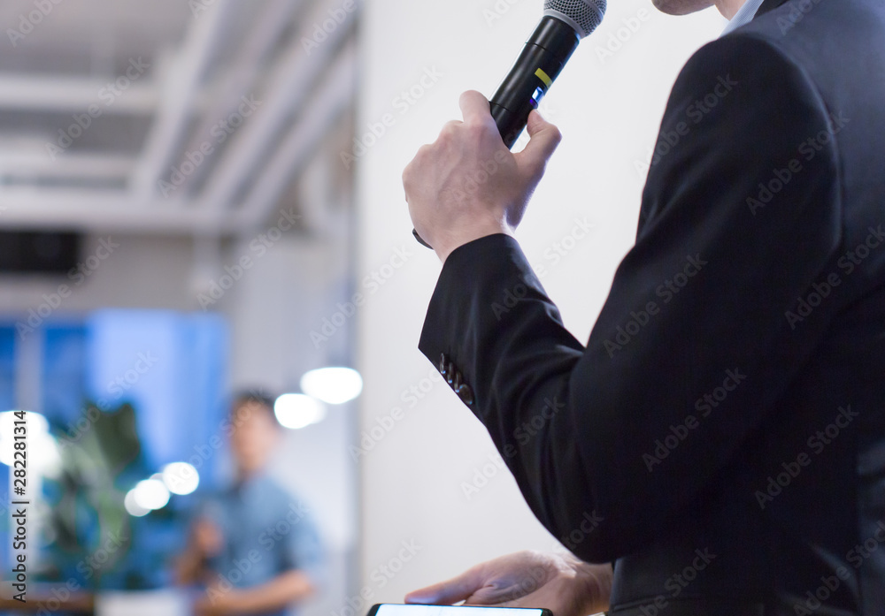 Speech given by professional speaker on stage at corporate conference ...