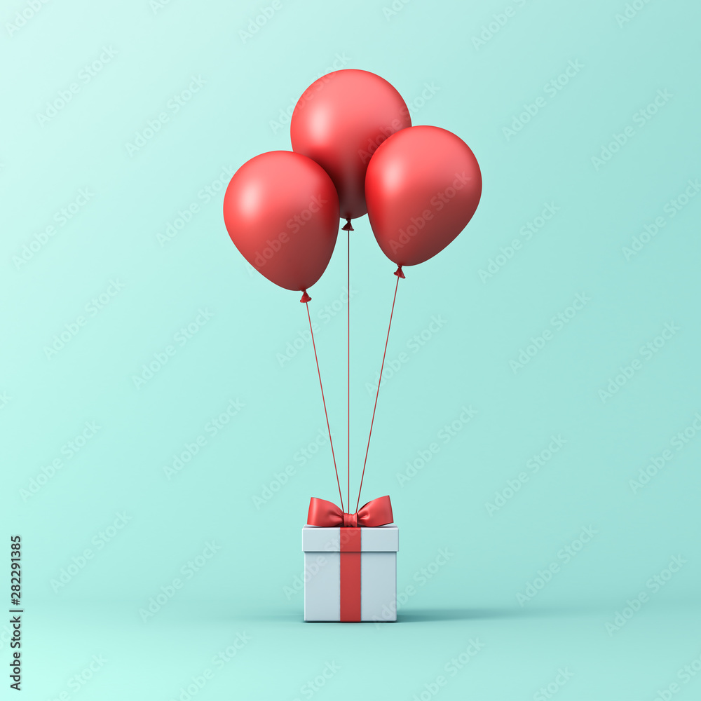 Red glossy balloons tied to gift box or present box with red ribbon and ...
