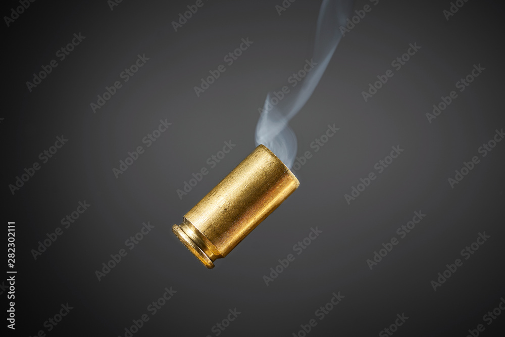 smoking bullet casing tumbling Stock Photo | Adobe Stock