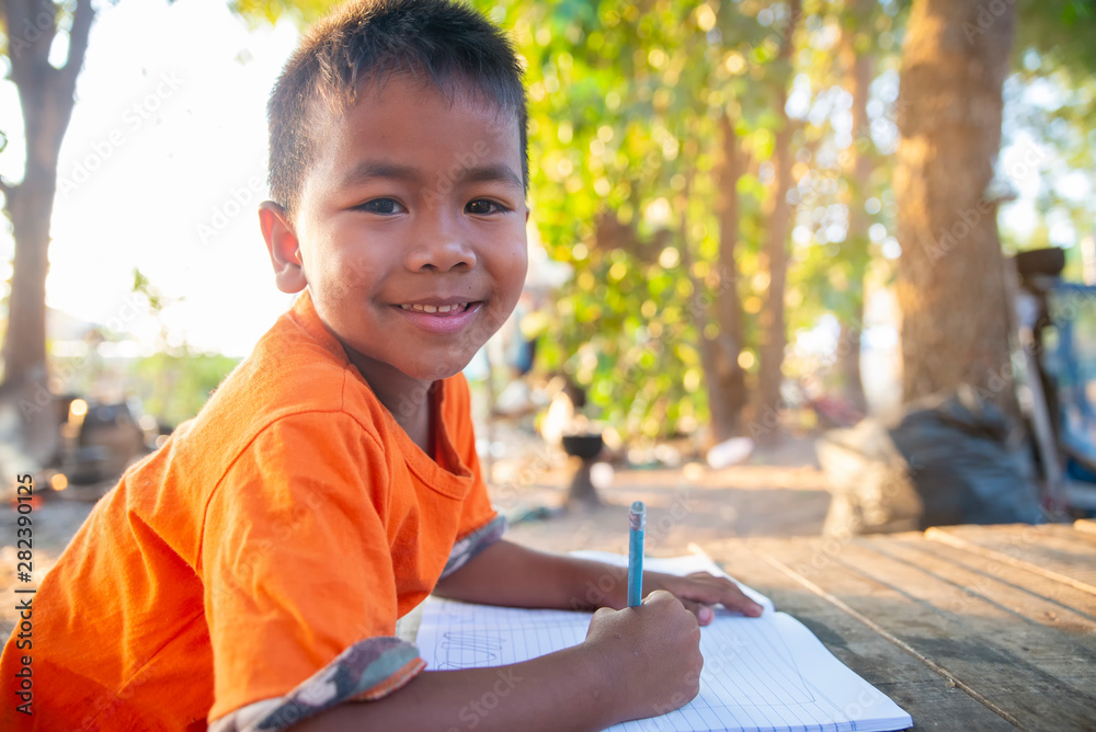 Asian child (poor kid) study at old home. Asia boy learning to drawing ...