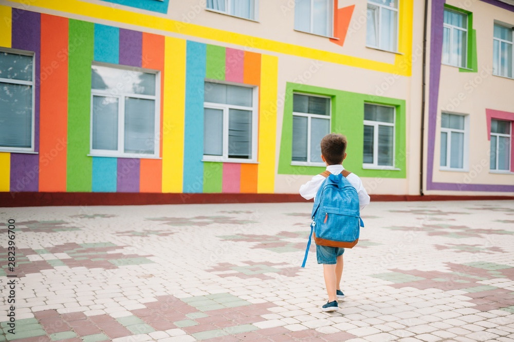 Little boy going back to school. Child with backpack and books on first ...