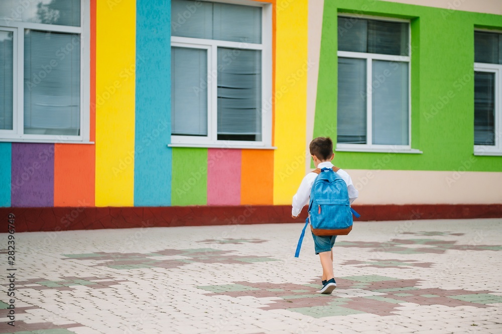 Little boy going back to school. Child with backpack and books on first ...