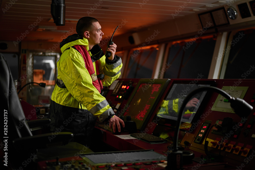Navigator. pilot, captain as pat of ship crew performing daily duties ...
