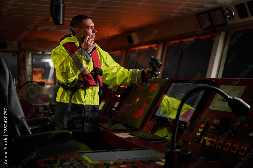 Navigator. pilot, captain as pat of ship crew performing daily duties ...