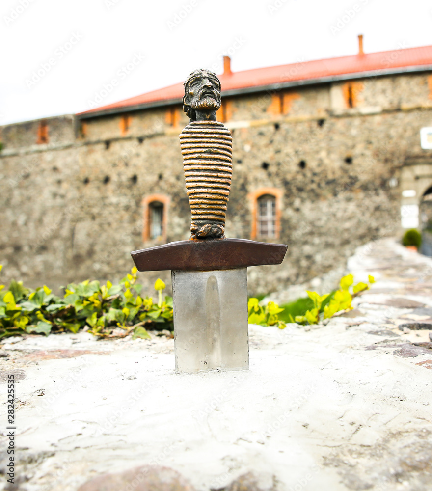 Sword in the stone near the castle. Saint Arthur's style medieval ...