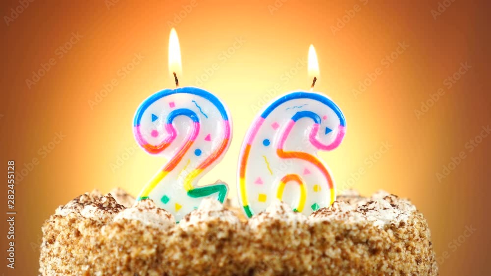 Vidéo Stock Birthday cake with a burning birthday candle. Number 26 ...