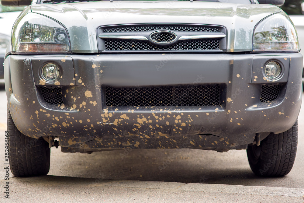 dirty car front view on an SUV with mud-stained bumper, close up. Stock ...