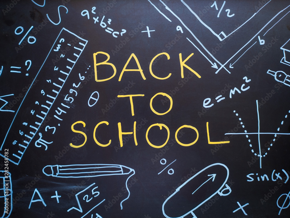 Back to School text on a blackboard surrounded by education related ...