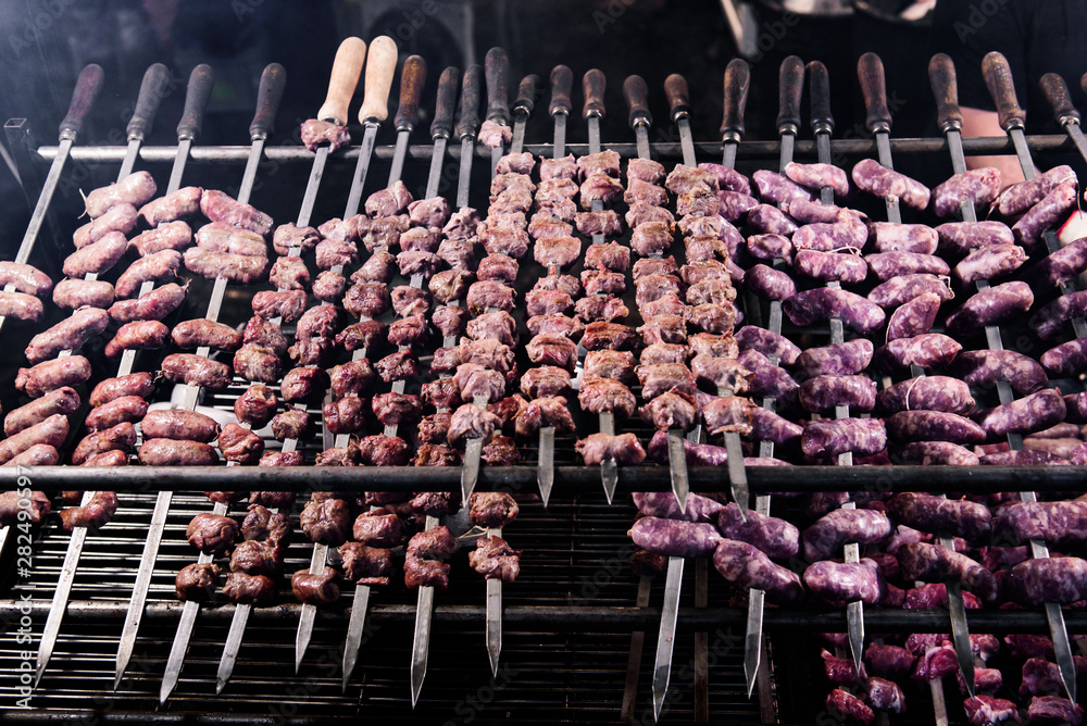 Meat on the grill. Grilled meat and spit-roasted meat during cooking ...