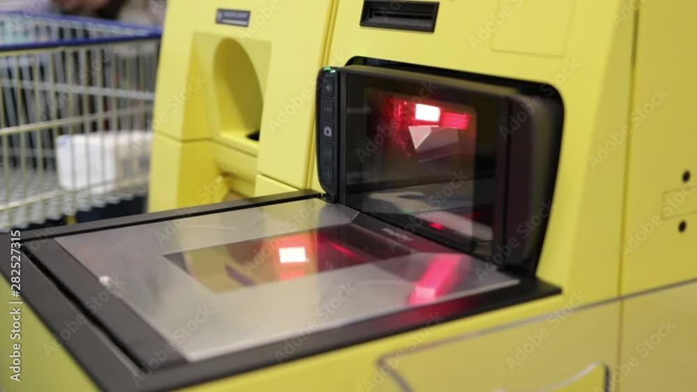 woman pays for purchases using a self-service machine with a touch ...