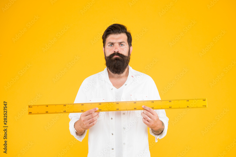 Does size really matter. Man bearded hipster holding ruler. Measure ...