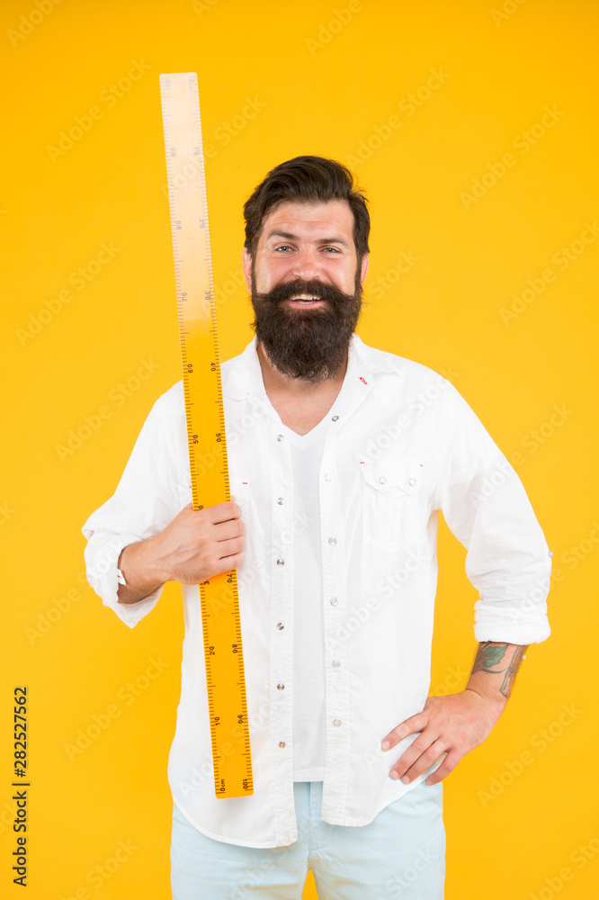 Man bearded hipster holding ruler. Measure length. Size tall and length ...