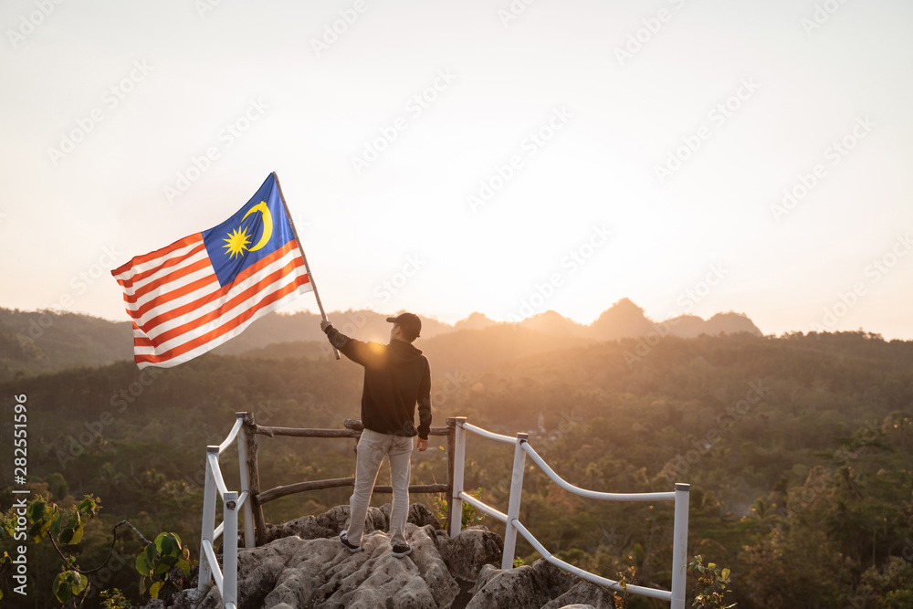 asian man with malaysian flag of malaysia on top of the mountain Stock ...