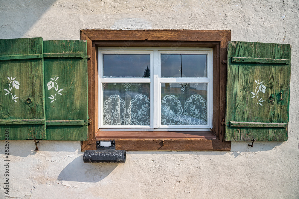 Old ancient wooden window with blinds, curtains and mailbox. Scenic ...