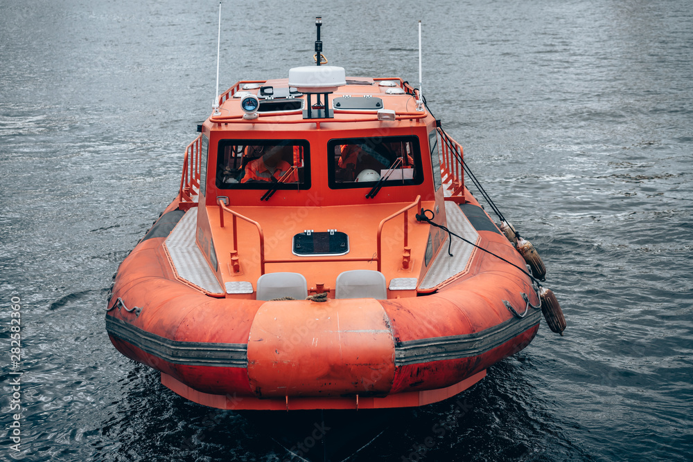 Marine rescue boat in the port on the water Stock Photo | Adobe Stock