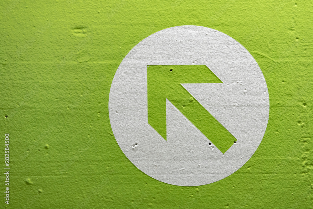 Bright green arrow sign in a white circle pointing up and to the left ...