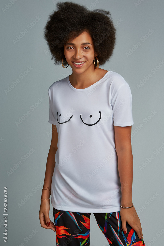 Three Quarter Shot Of Dark Skinned Girl With Afro Hairstyle Wearing White T Shirt With Tits