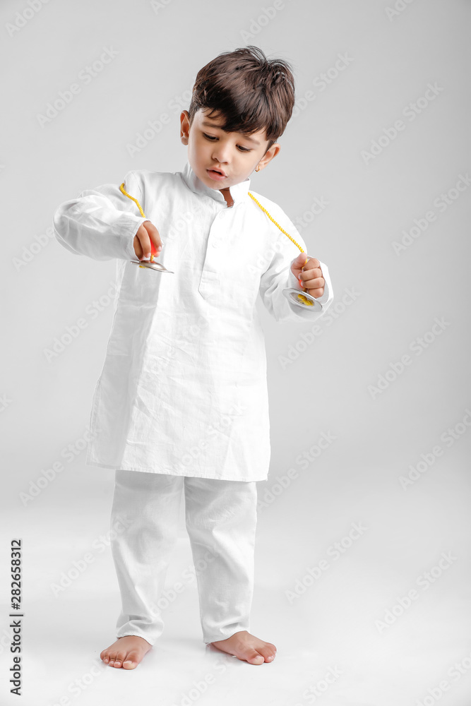 Indian Little Boy in Traditional Dress and learning with Musical ...