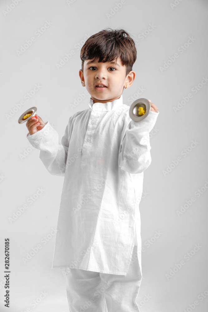 Indian Little Boy in Traditional Dress and learning with Musical ...