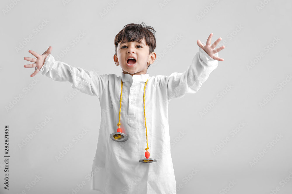 Indian Little Boy in Traditional Dress and learning with Musical ...