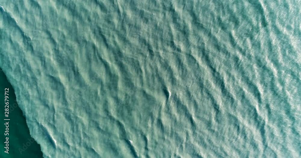 Aerial top-down pan of glacial meltwater rich in silica coming from ...