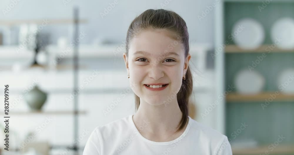 FIXED Portrait of little cute Caucasian girl looking and smiling into ...