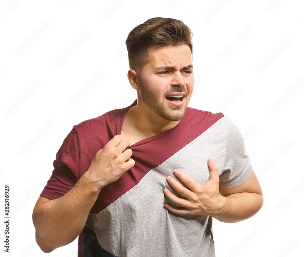 Young man suffering from heart attack on white background Stock Photo ...