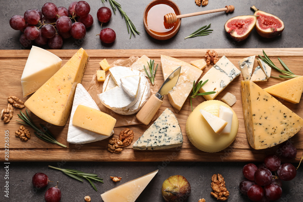 Flat lay composition with different types of delicious cheese on table ...