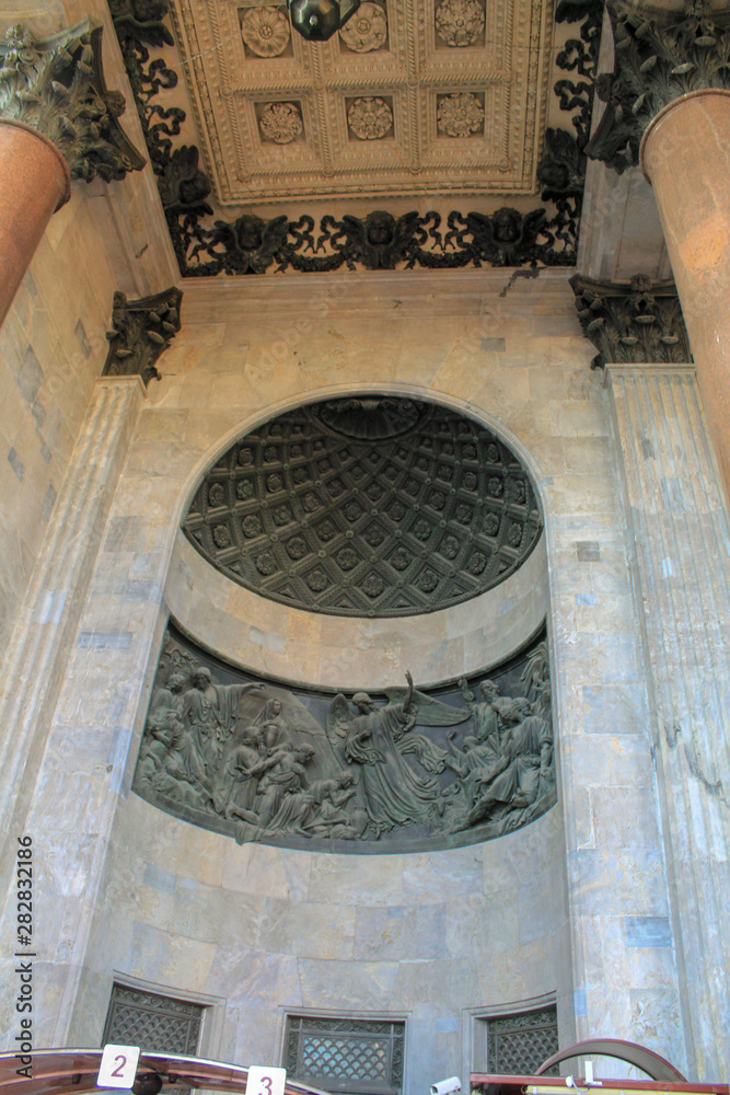 Stone arch inside the building with a round dome and carved scenes of ...