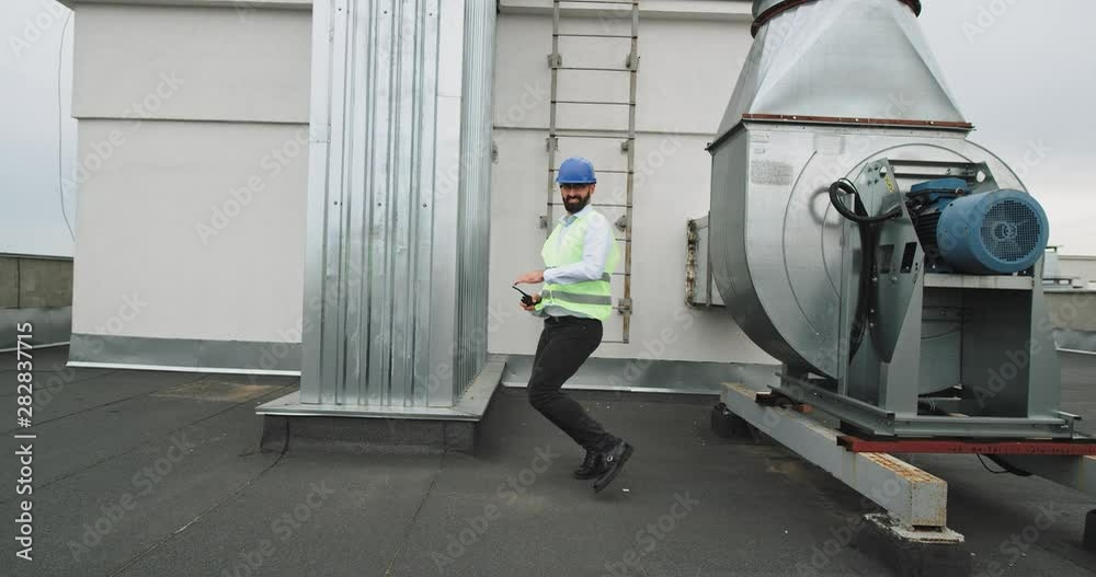 Charismatic and smiling large architect or engineer dancing excited in ...