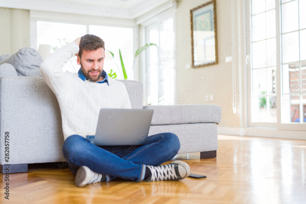 Handsome man wearing working using computer laptop stressed with hand ...