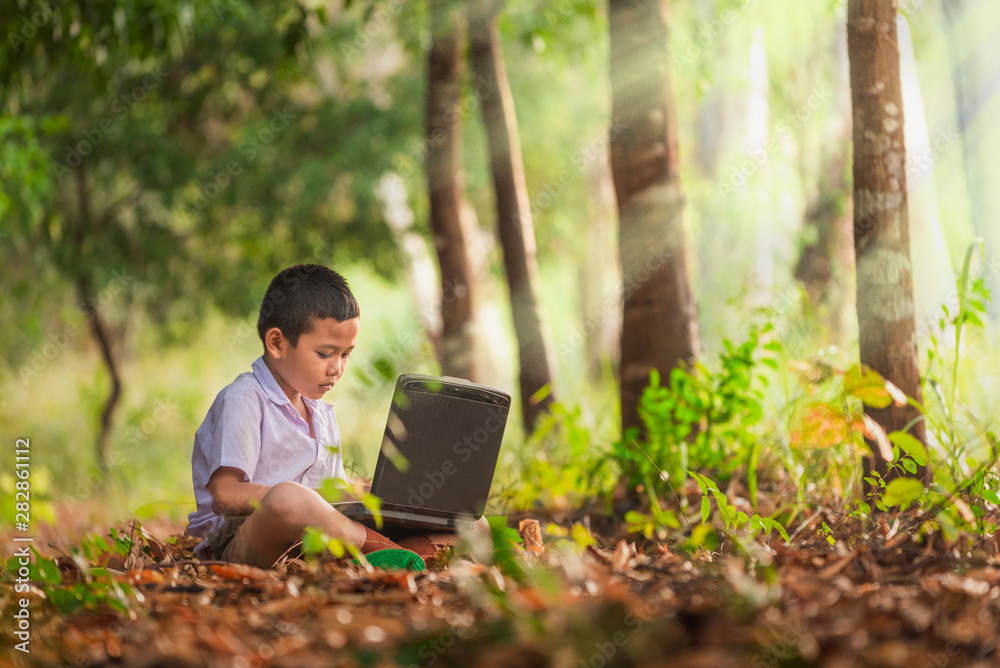 Asian teen boy using laptop computer at outdoor, White screen on laptop ...