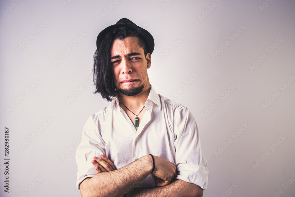 Portrait of young latin with disgusted face and disgust, isolated on ...