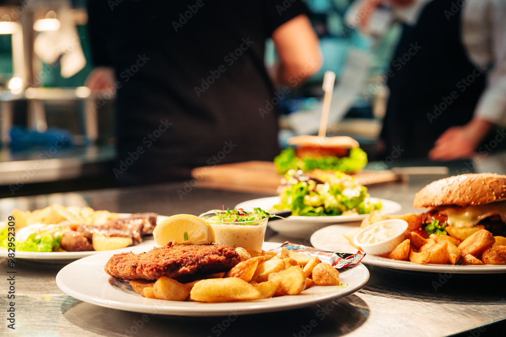 Food orders on the kitchen table in the restaurant Stock Photo | Adobe ...