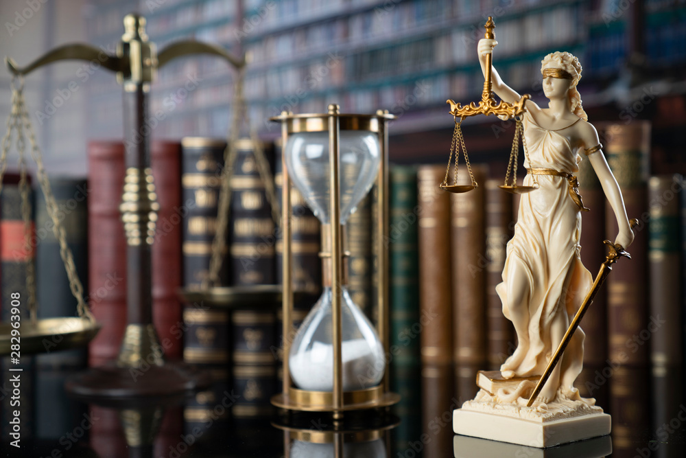 The law concept background. White statue of Themis, gavel, legal books ...