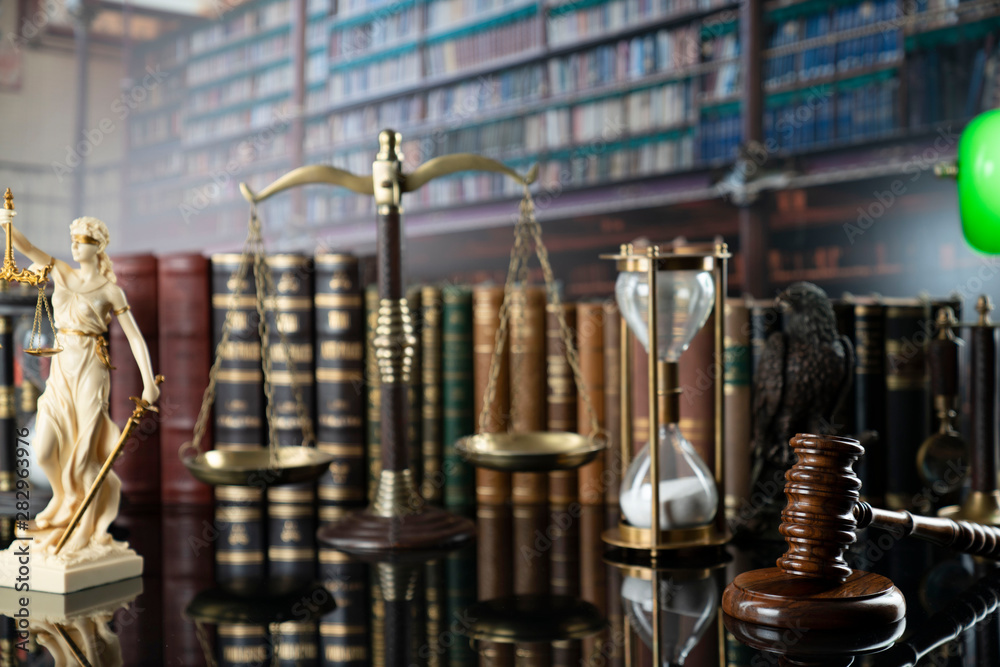 The law concept background. White statue of Themis, gavel, legal books ...