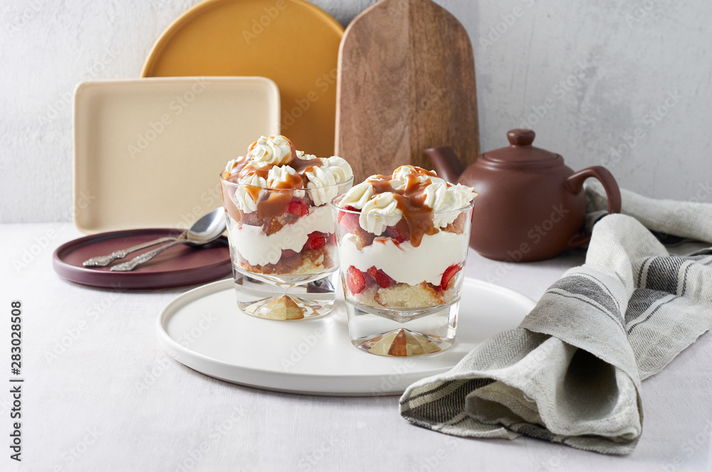 Layered dessert Trifle with vanilla cake, whipped cream, salted caramel ...