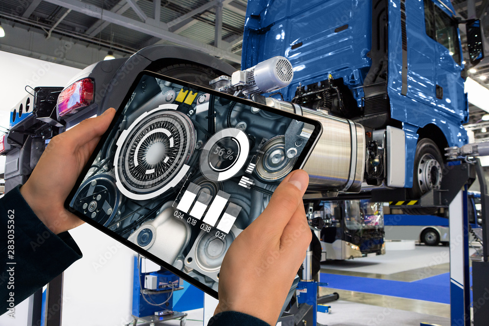 Serviceman repairing a truck using augmented reality application. Stock ... Serviceman repairing a truck using augmented reality application. Stock ...