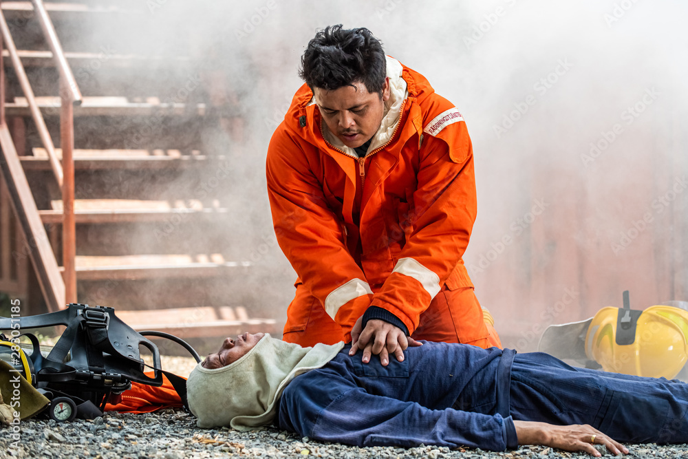 Medium shot of firefighter in fire suit on safety rescue duty help stop ...