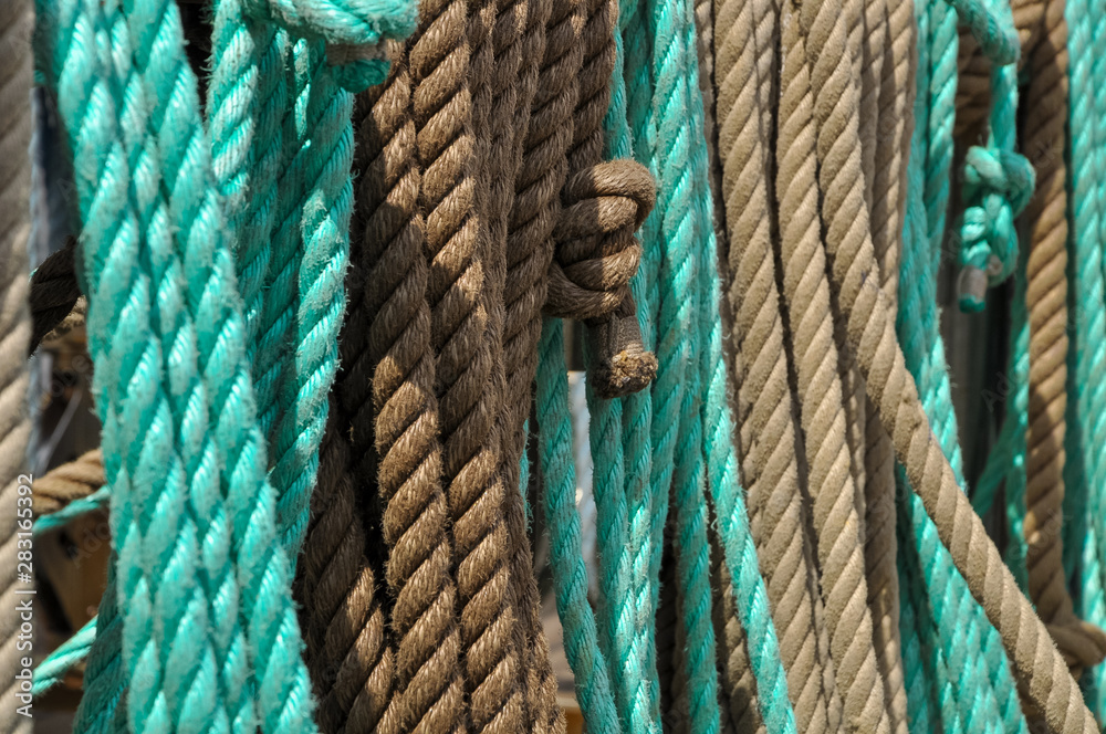 Spiral ship rope lying down on dark brown deck as background texture ...