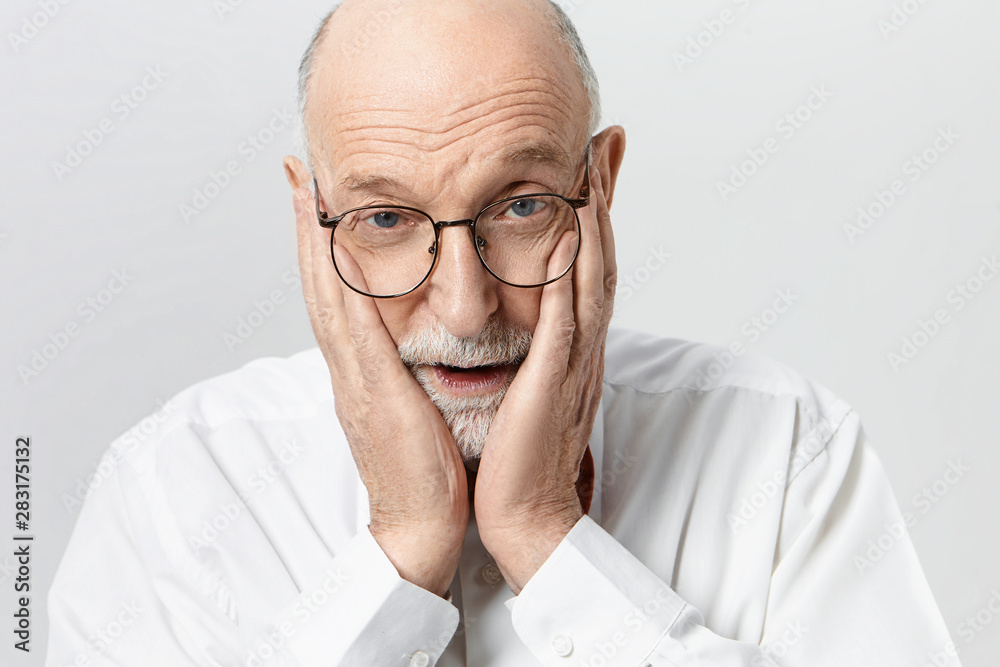 Portrait of emotional desperate elderly man with beard and bald head ...