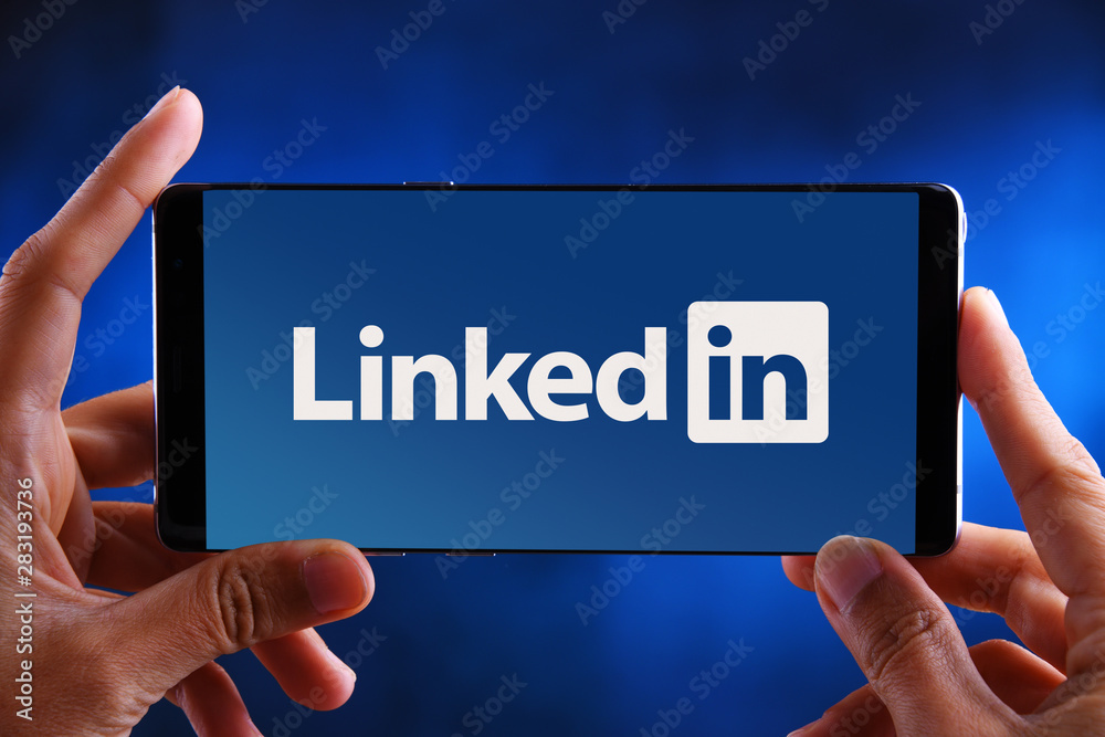 Hands holding smartphone displaying logo of LinkedIn Stock Photo ...