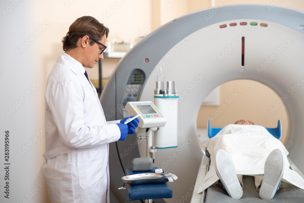 Doctor preparing catheter during CT scan procedure Stock Photo | Adobe ... Doctor preparing catheter during CT scan procedure Stock Photo | Adobe ...