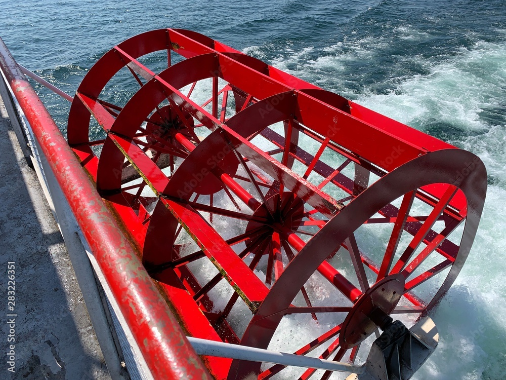 Red paddle wheel of a boat up close Stock Photo | Adobe Stock