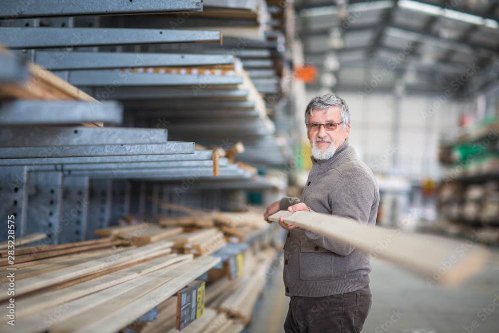 Man choosing and buying construction wood in a DIY store for his DIY ...
