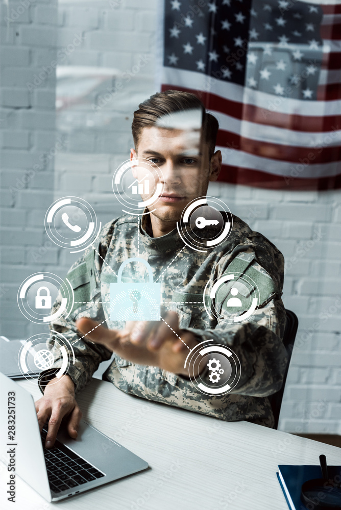 Handsome soldier in military uniform pointing with finger at virtual ...