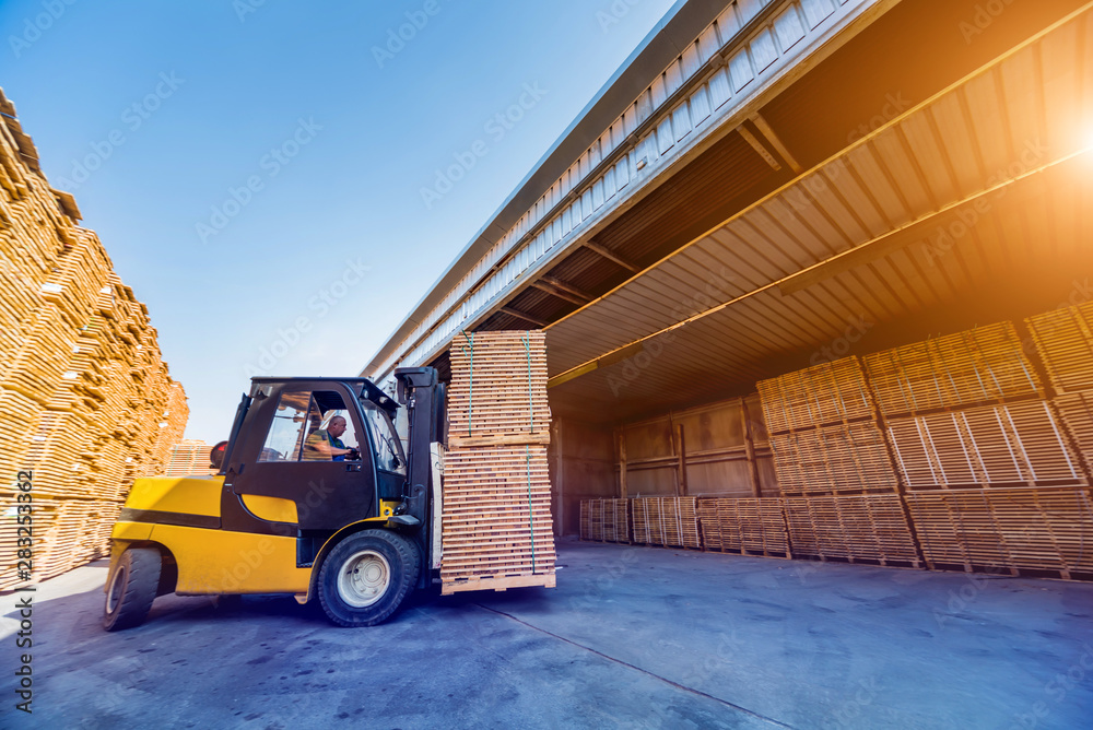 Forklift loader load lumber into a dry kiln. Wood drying in containers ...