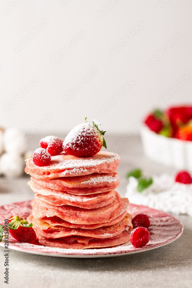 Stack of pink pancakes with strawberry. Pink colourful pancakes with ...