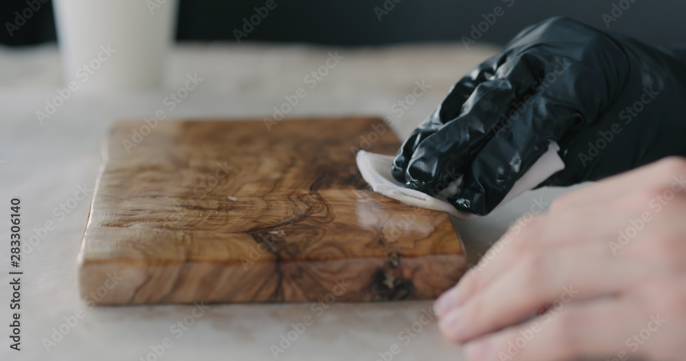 woodworker applying oil finish to olive wood board Stock Photo | Adobe ...