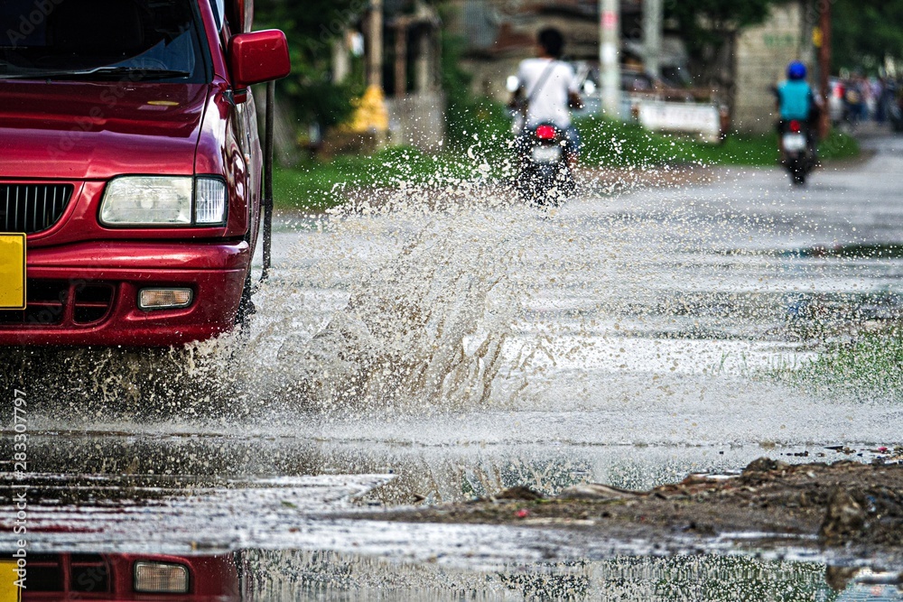 motion car rain big dirty puddle of water spray from the wheels ...